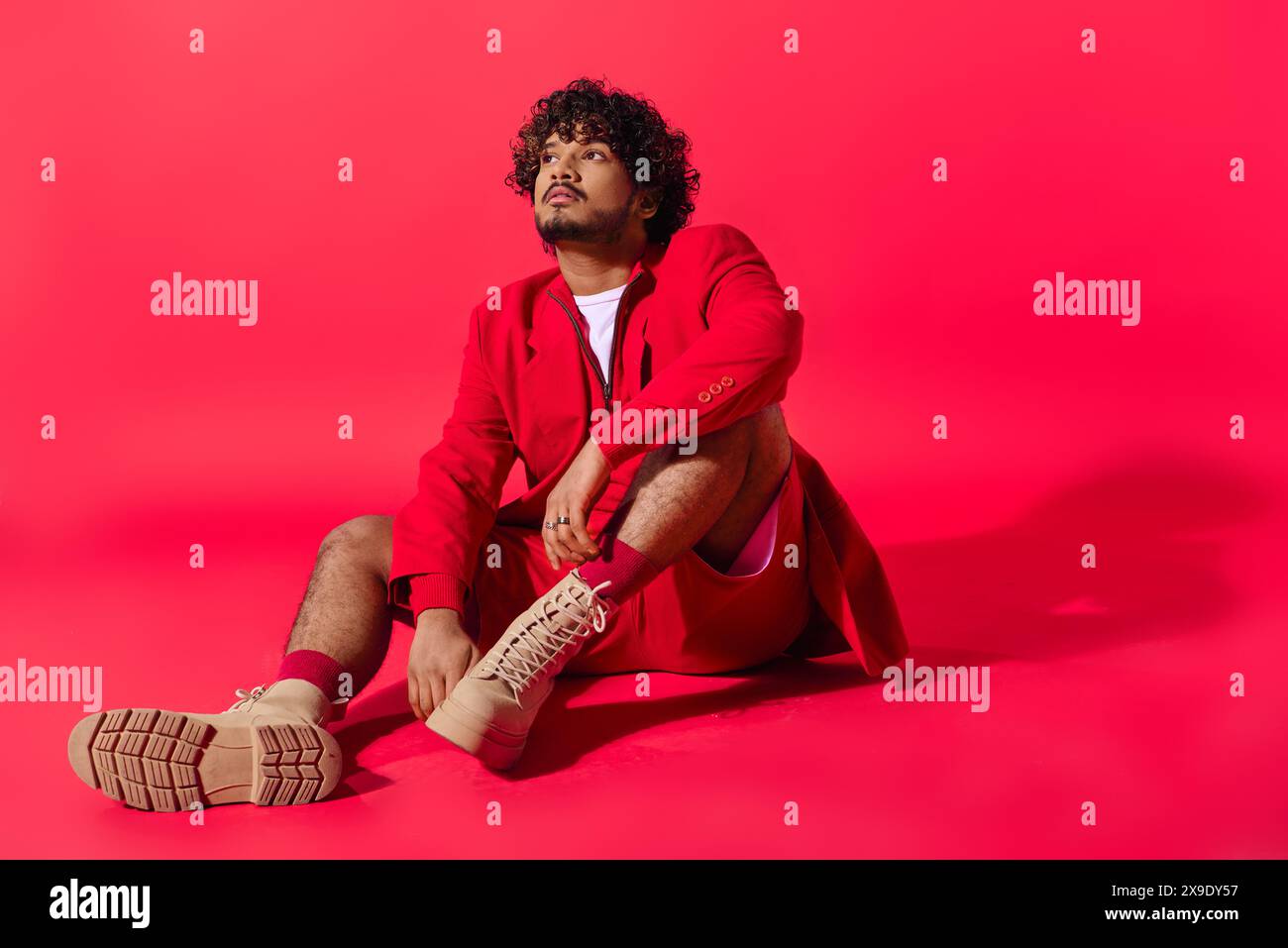 Handsome Indian man in vibrant outfit siting and looking away Stock ...