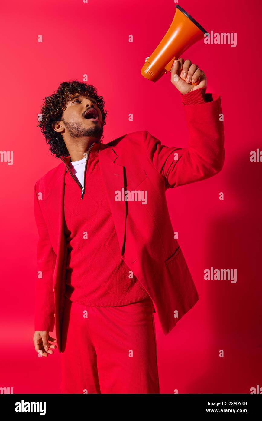 Vibrant Indian man in red suit holding a megaphone Stock Photo - Alamy