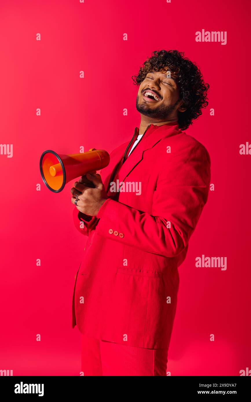 Handsome Indian man in red suit with red and yellow megaphone Stock ...