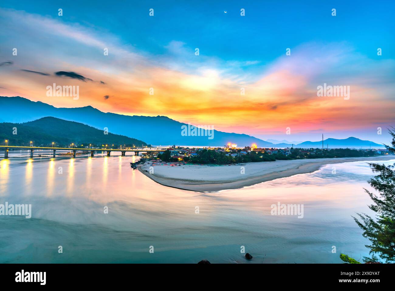 Lang Co bay in the sunset with a small fishing village completely below ...