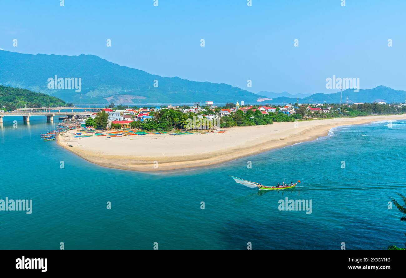 Lang Co bay in the sunset with a small fishing village completely below ...