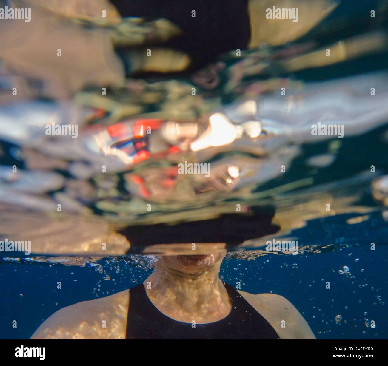 Woman swimming underwater bubbles hi-res stock photography and images ...