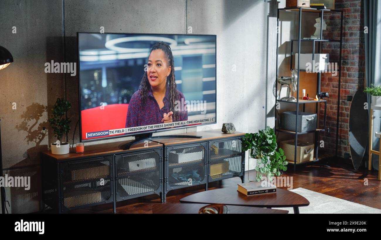 Living Room Television Showing TV News Programme with Two Presenters Talking and Joking on TV ...