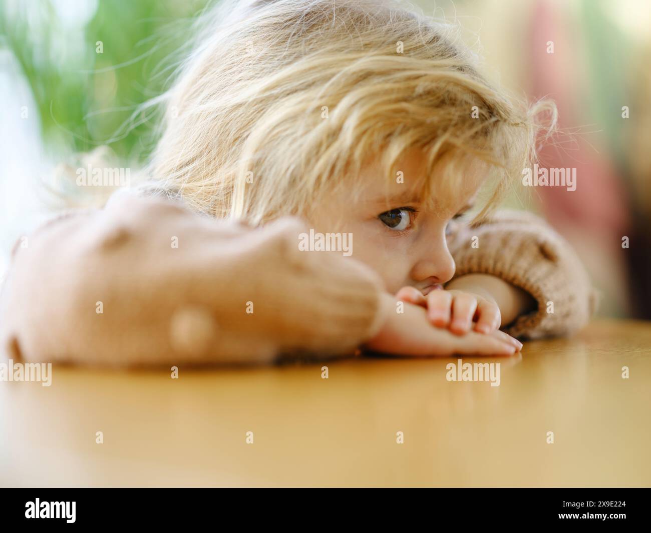 A little sad girl looks thoughtfully into the distance Stock Photo - Alamy