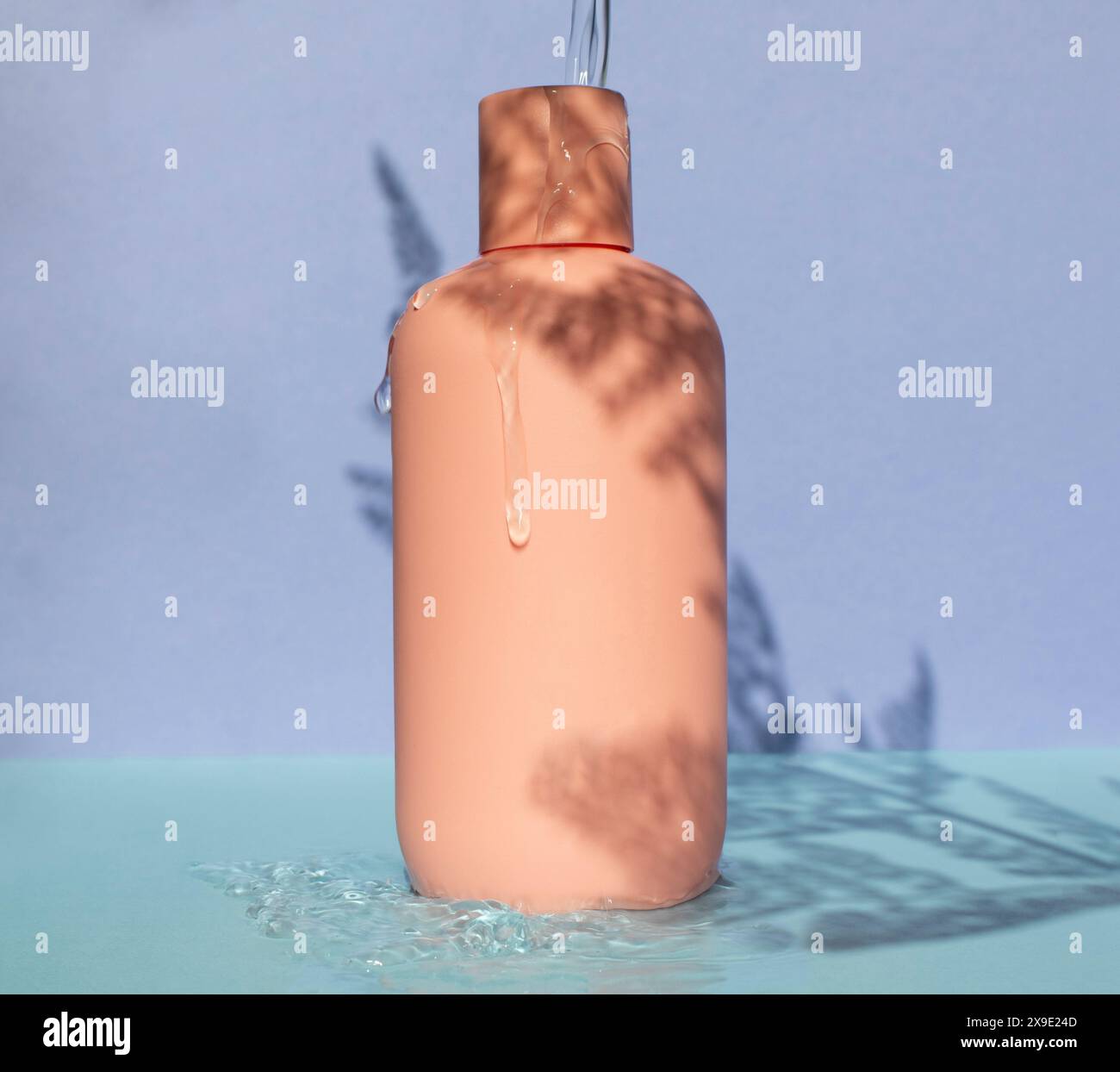 pink product shampoo bottle on a background with water Stock Photo - Alamy