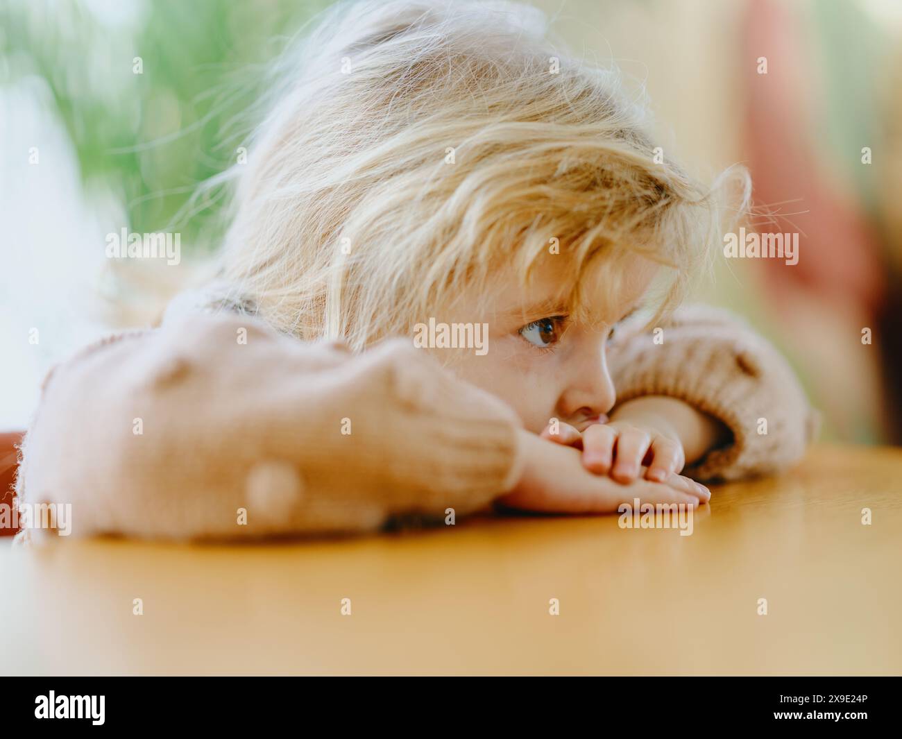 A little sad girl looks thoughtfully into the distance Stock Photo - Alamy