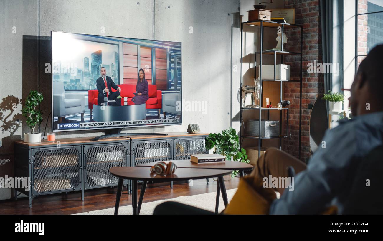 Boyfriend and Girlfriend Watching News Show on TV While Sitting on a ...
