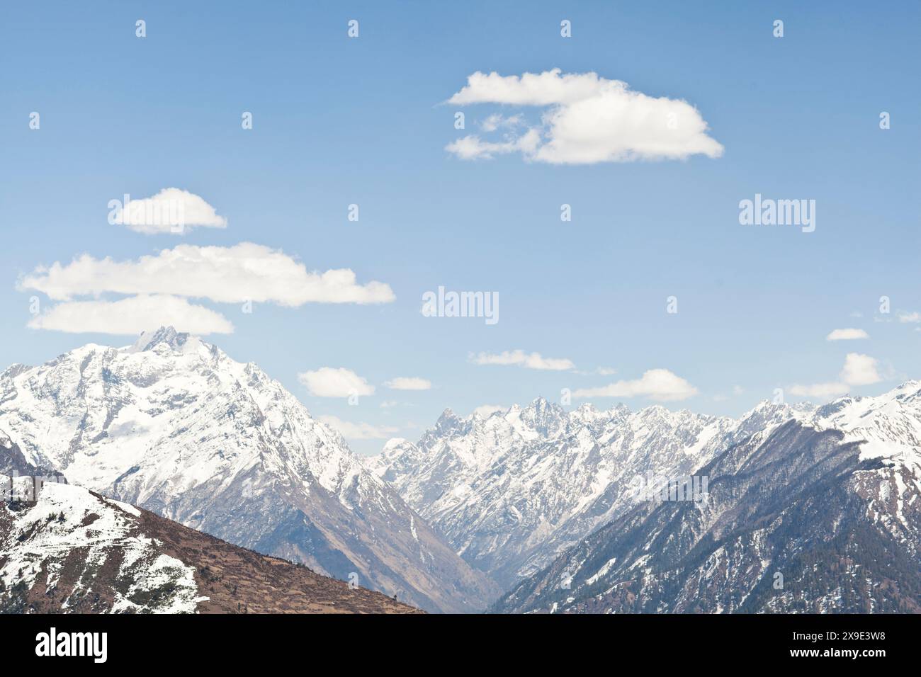 Himalayan snow capped mountain peaks with blue skies Stock Photo - Alamy