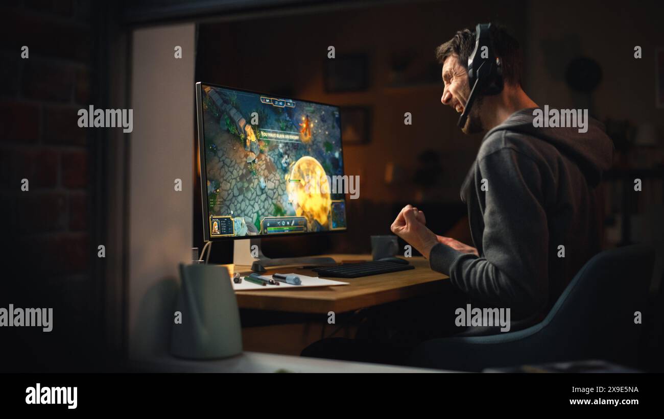 Excited Middle Aged Male Gamer Playing Online Video Game on Personal ...