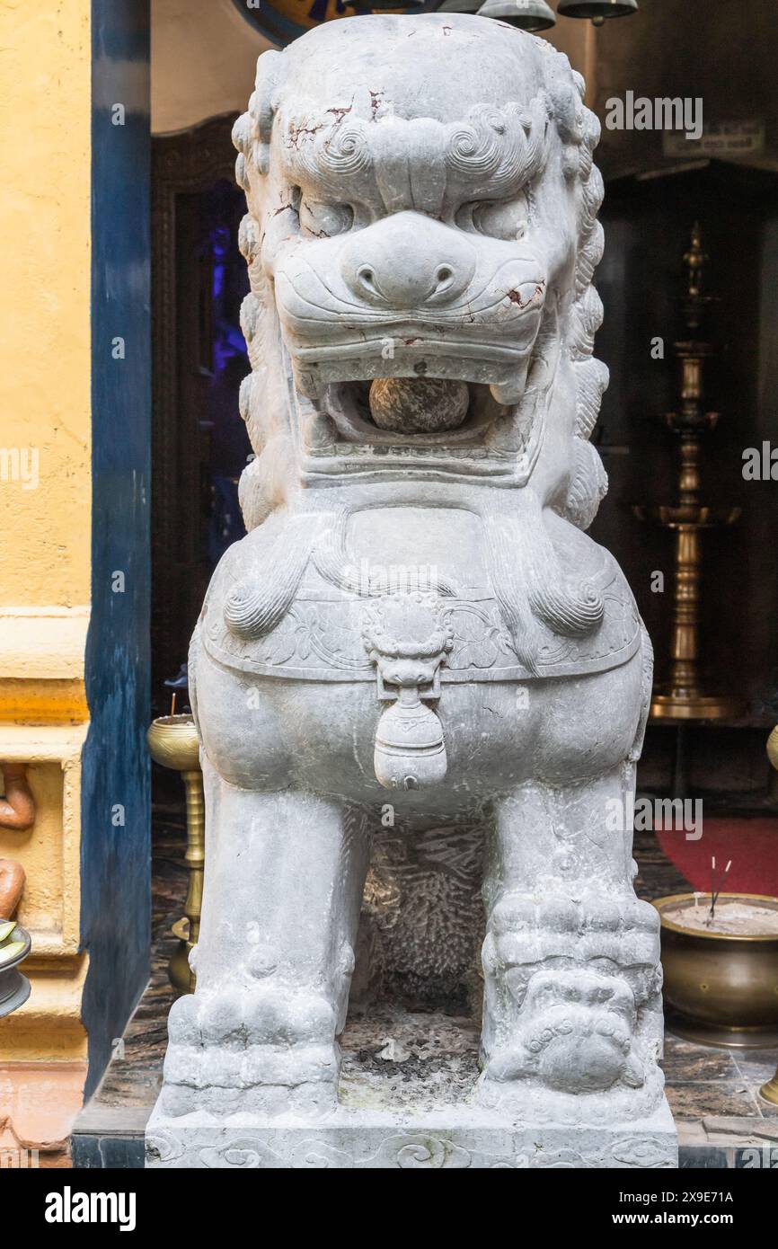 Front view of a stone guard lion statue at Gangaramaya Temple, the most ...