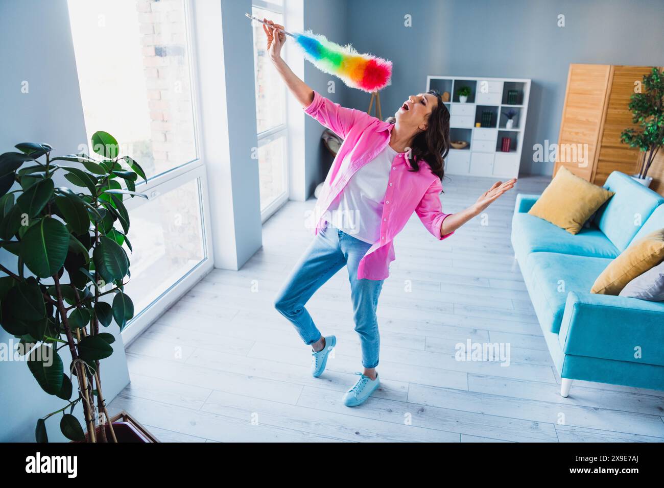 Full size photo of lovely retired lady sing duster have fun cleaning ...