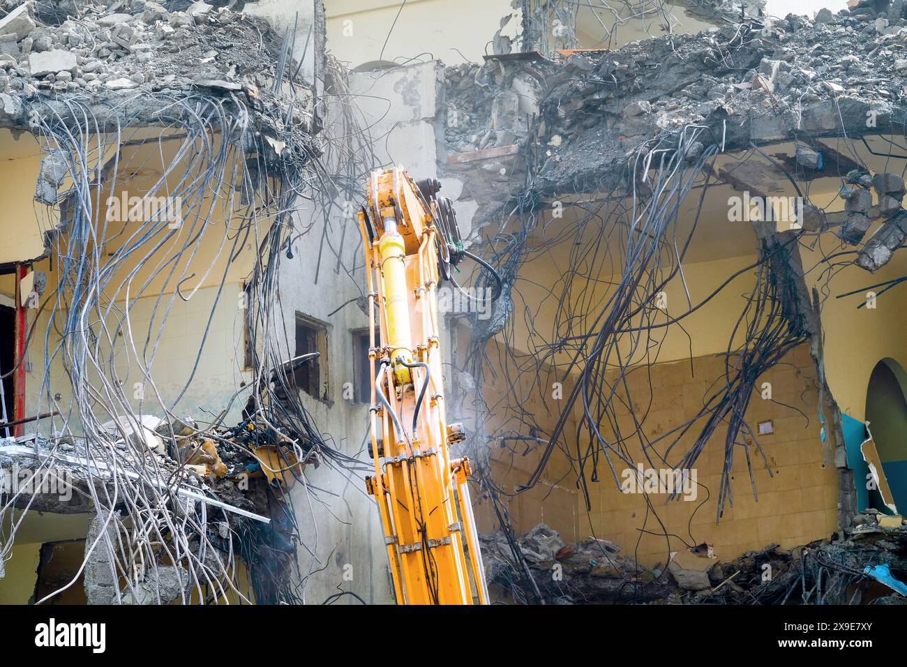An special excavator destroys an old concrete house. Lots of twisted ...