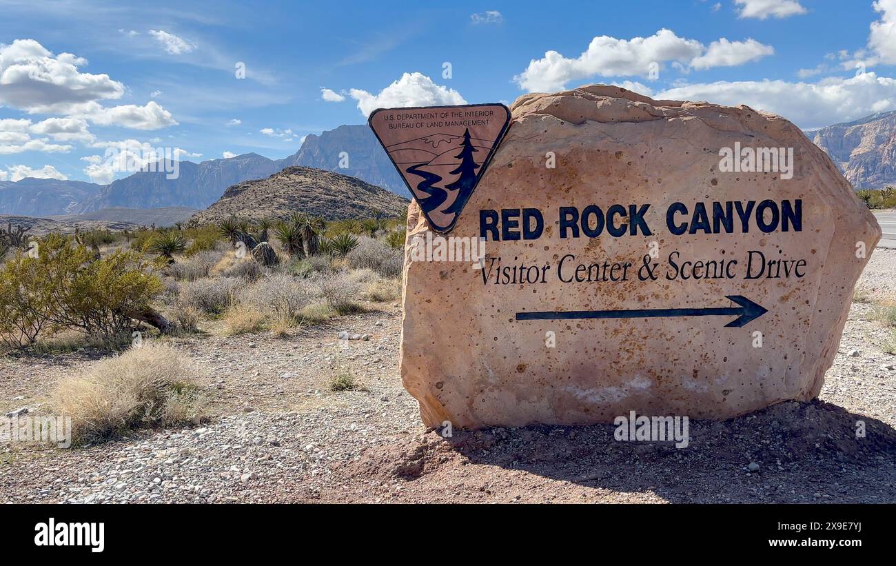 Direction sign on a large sandstone boulder for the Red Rock Canyon ...