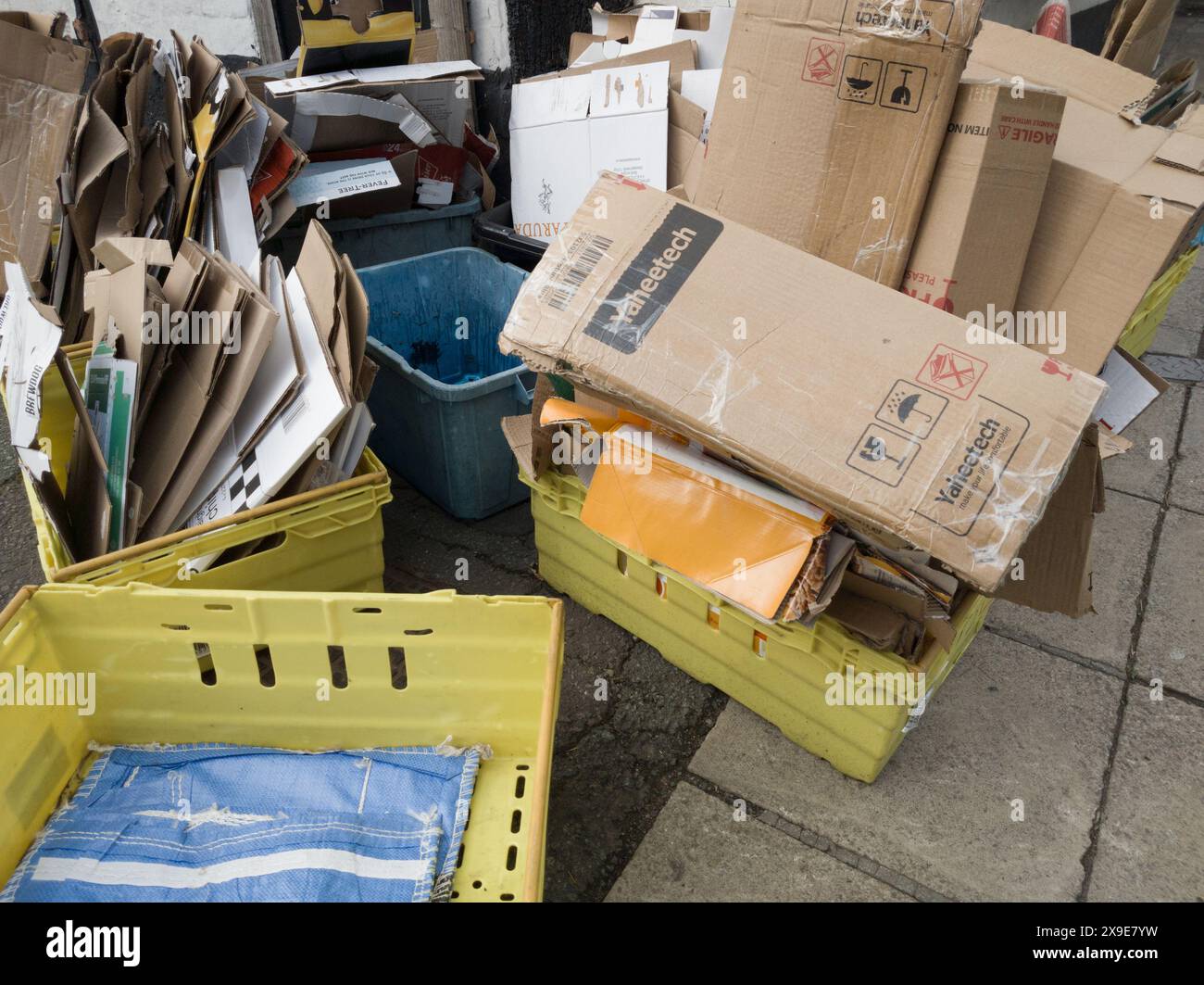 Packaging waste awaiting collection in town centre Stock Photo - Alamy