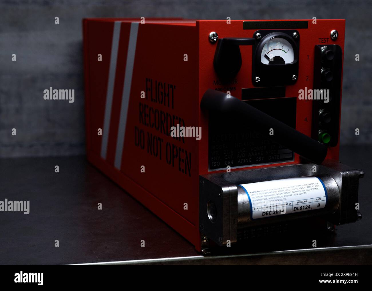 A regular aviation flight recorder black box painted in orange on metal ...