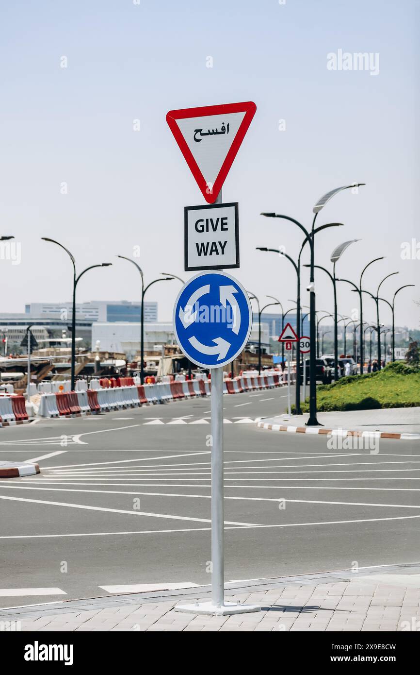 Roundabout and give way traffic sign in Doha, Qatar Stock Photo - Alamy