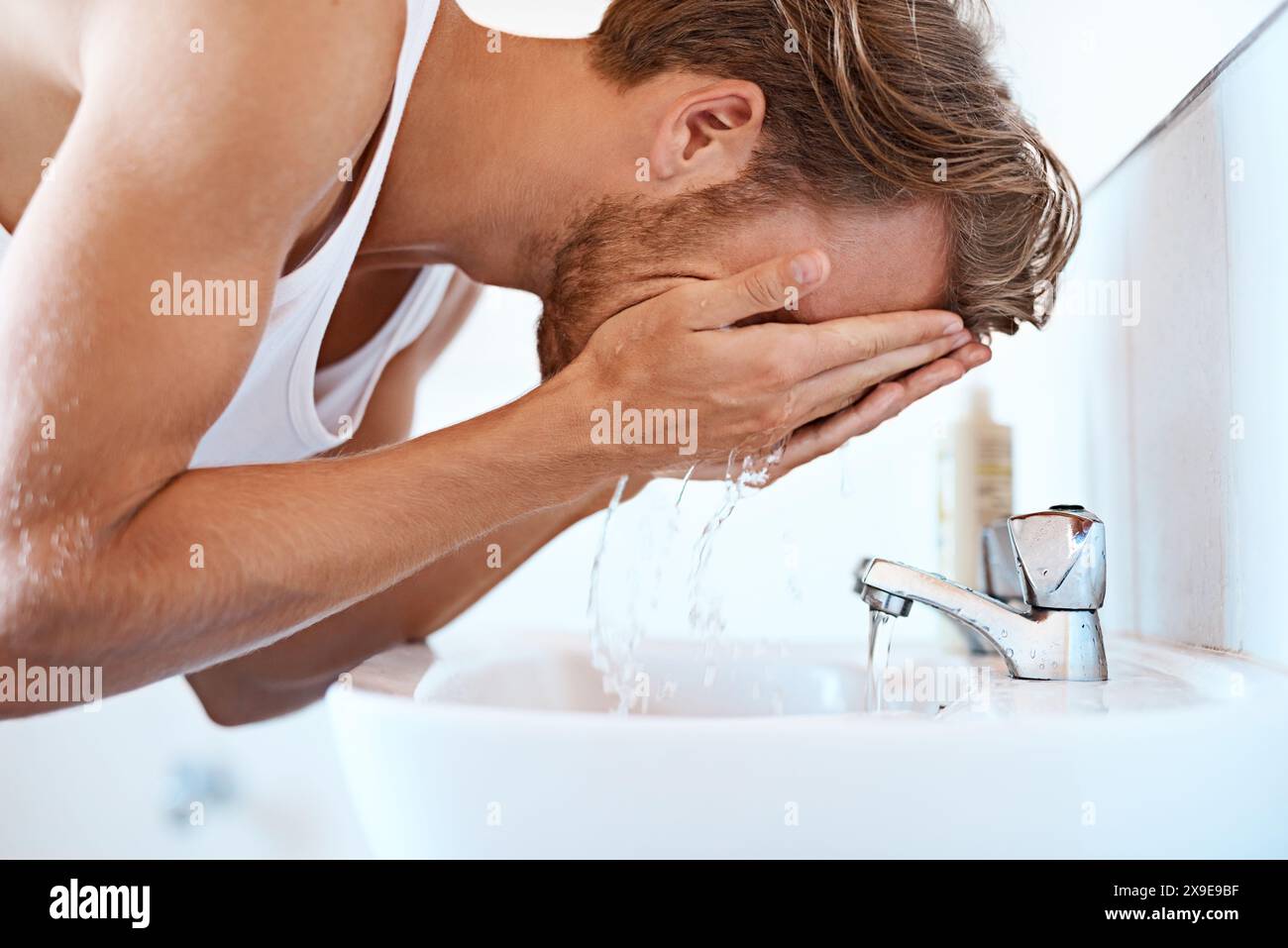 Water, cleaning and hands of man in bathroom for washing face, hygiene ...