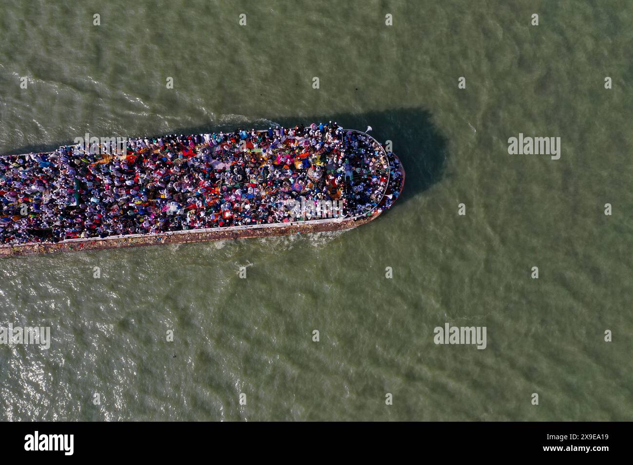 Devotees crowd the rooftops of vessels as they journey to attend the ...