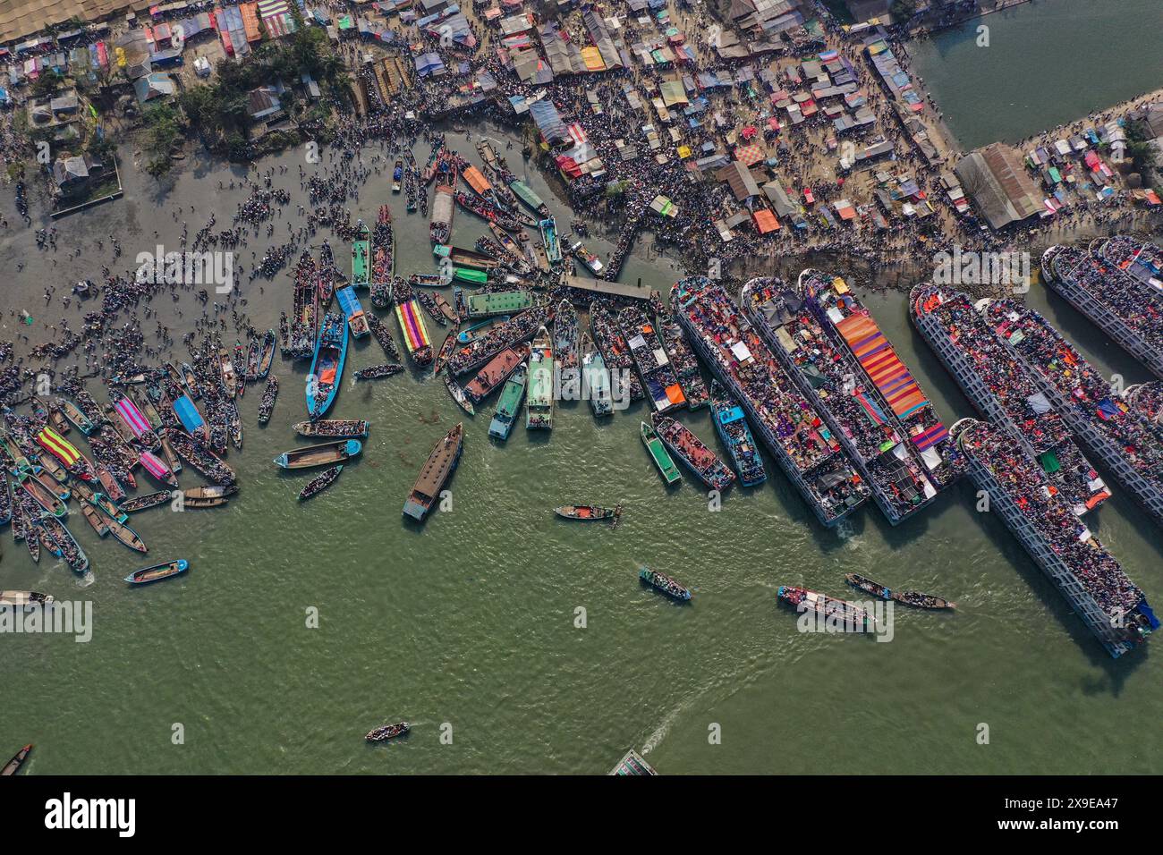 Devotees crowd the rooftops of vessels as they journey to attend the ...