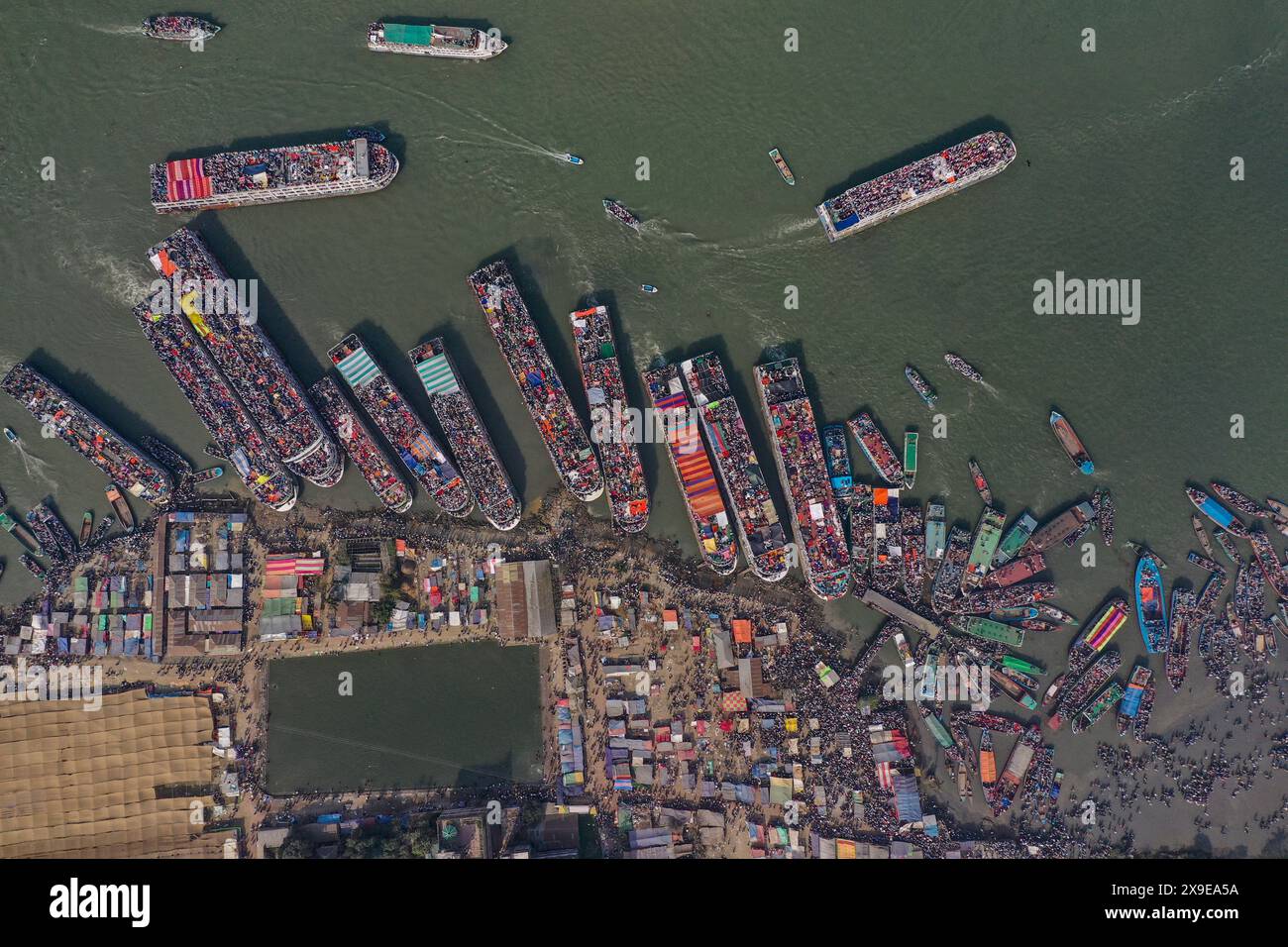 Devotees crowd the rooftops of vessels as they journey to attend the ...