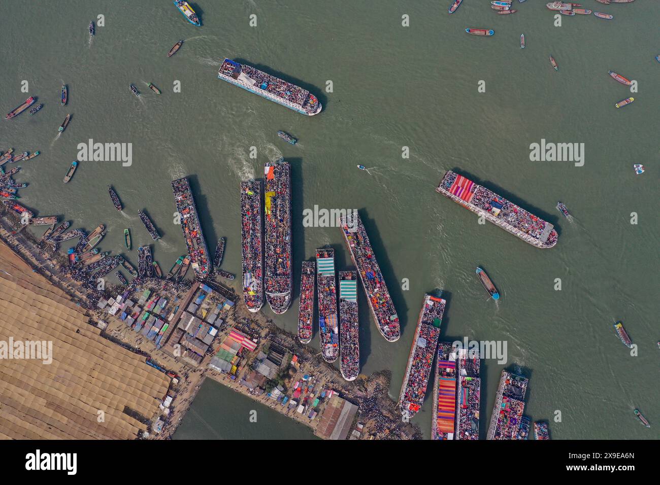 Devotees crowd the rooftops of vessels as they journey to attend the ...
