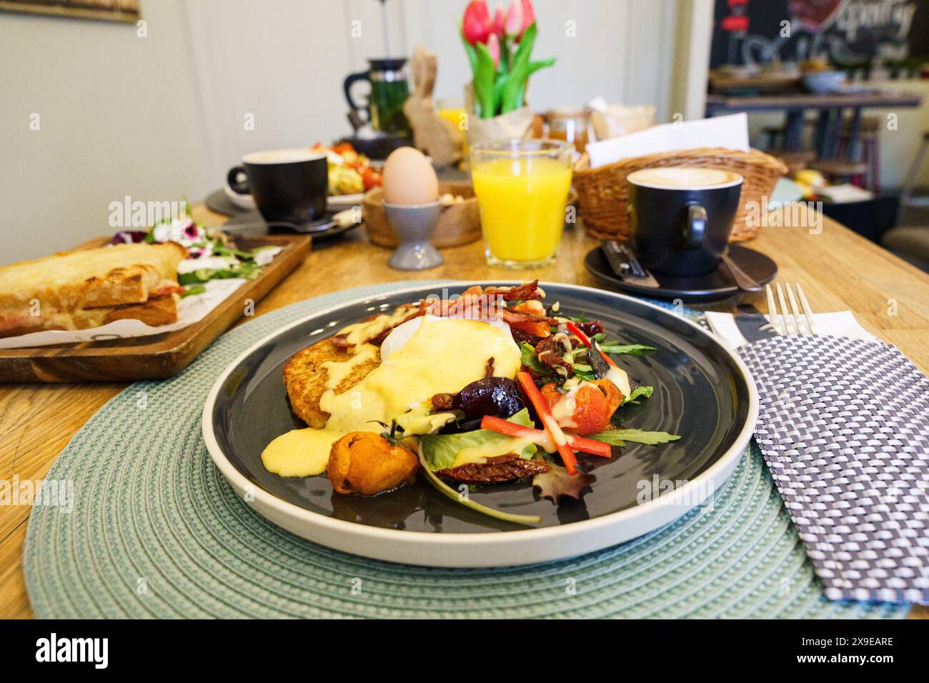 Fried bacon with poached eggs, hash browns and vegetables Stock Photo ...