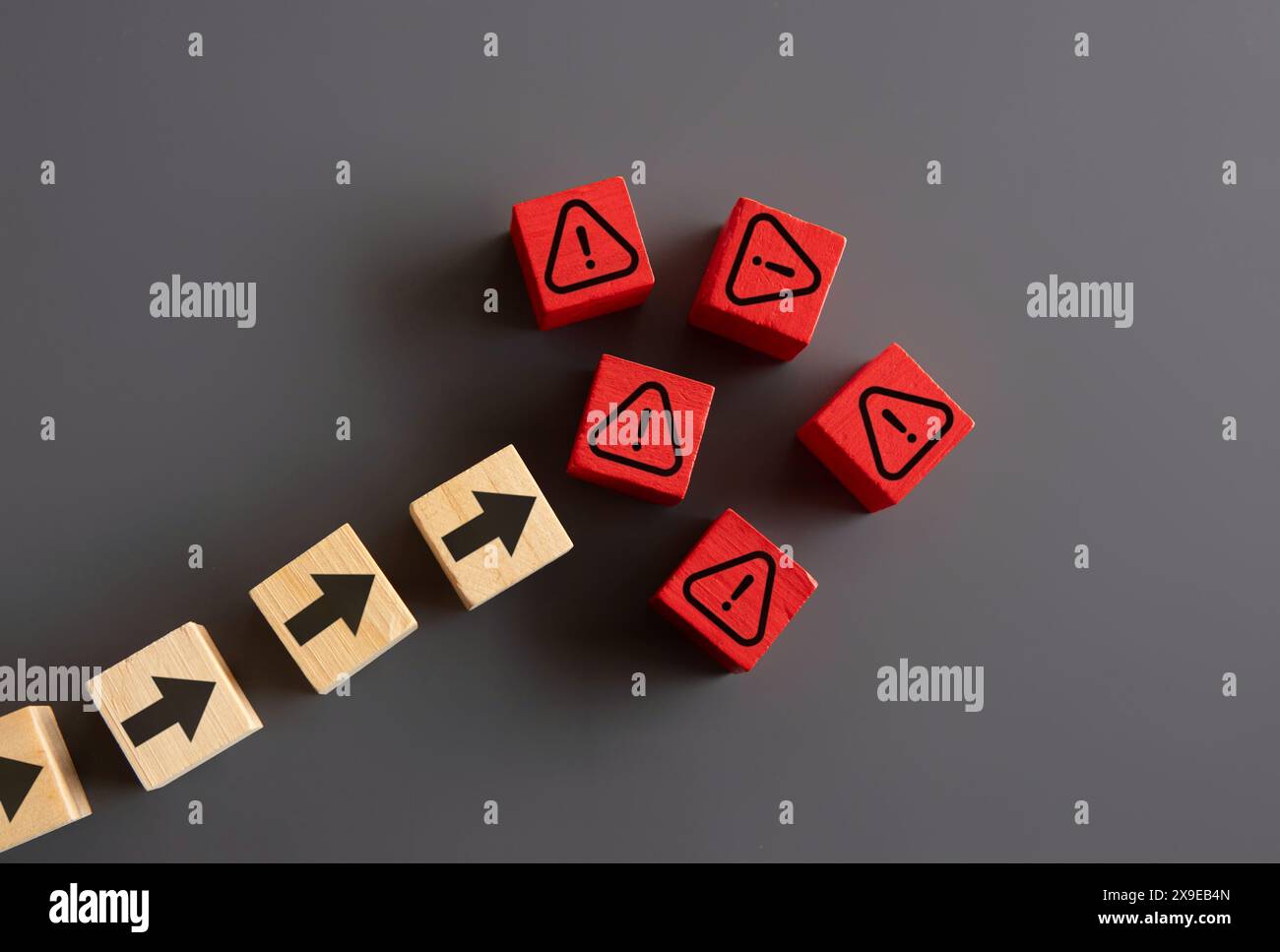 Wooden blocks with upward arrow and warning icon. Challenges, obstacle ...