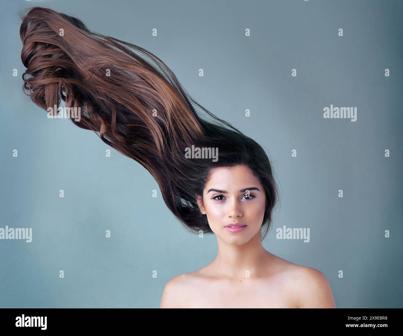 Woman, studio or portrait with movement in hair care and makeup ...