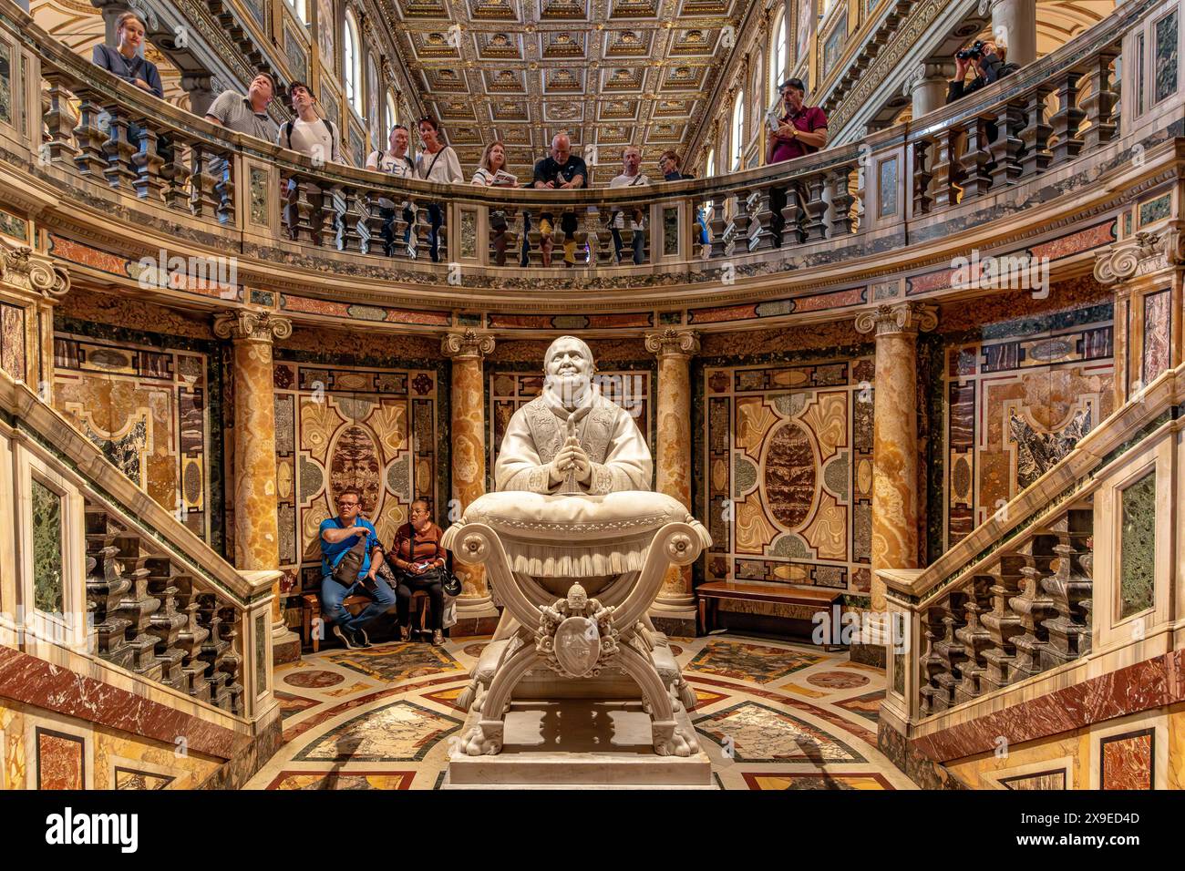 Visitors view a statue of Pope Pius IX at the crypt of the confession ...
