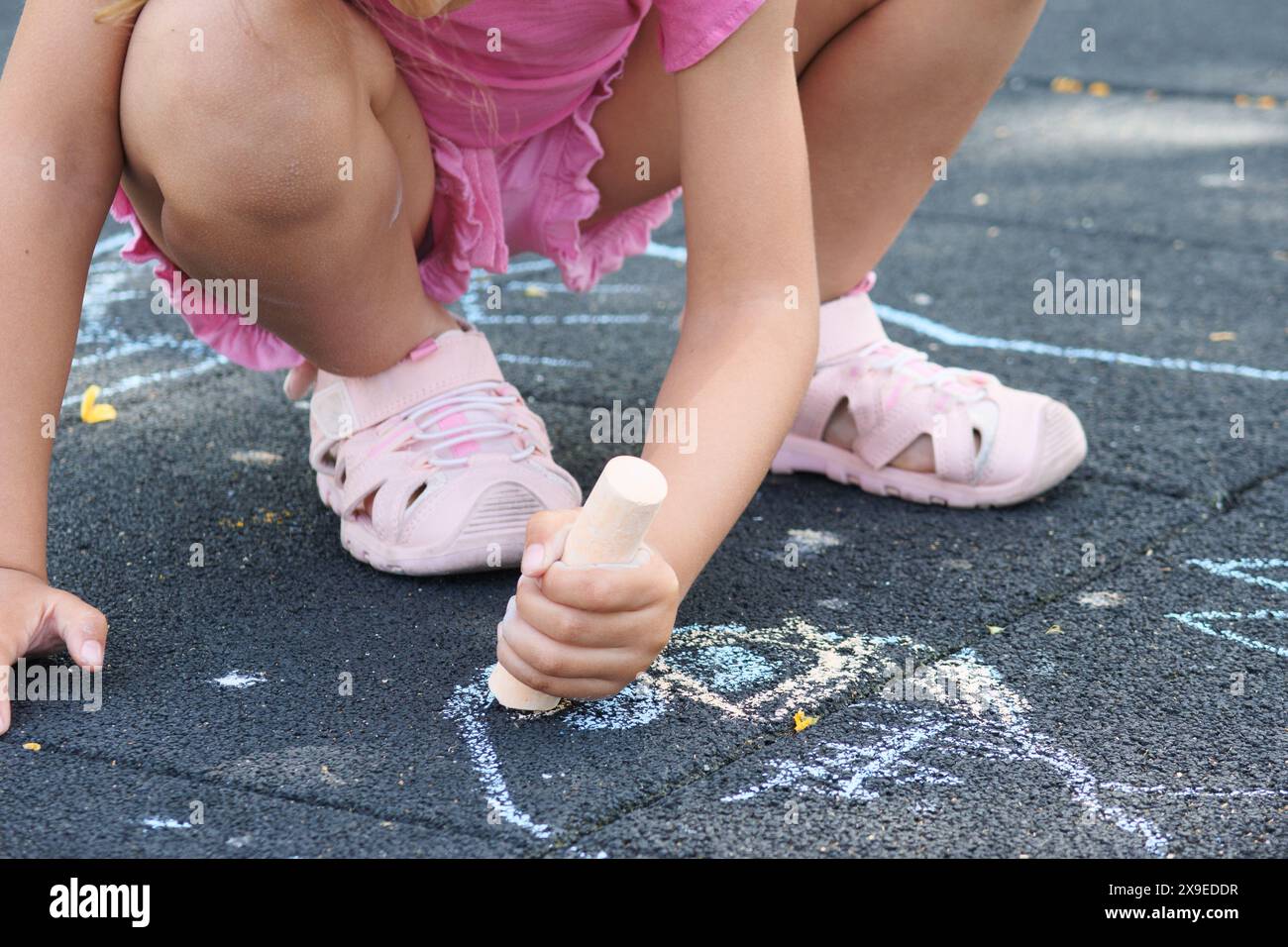 Unrecognizable girl drawing on the floor with colored chalks Stock ...