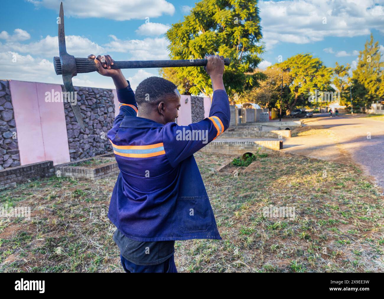african worker with a pickaxe digging the soil in the street Stock ...