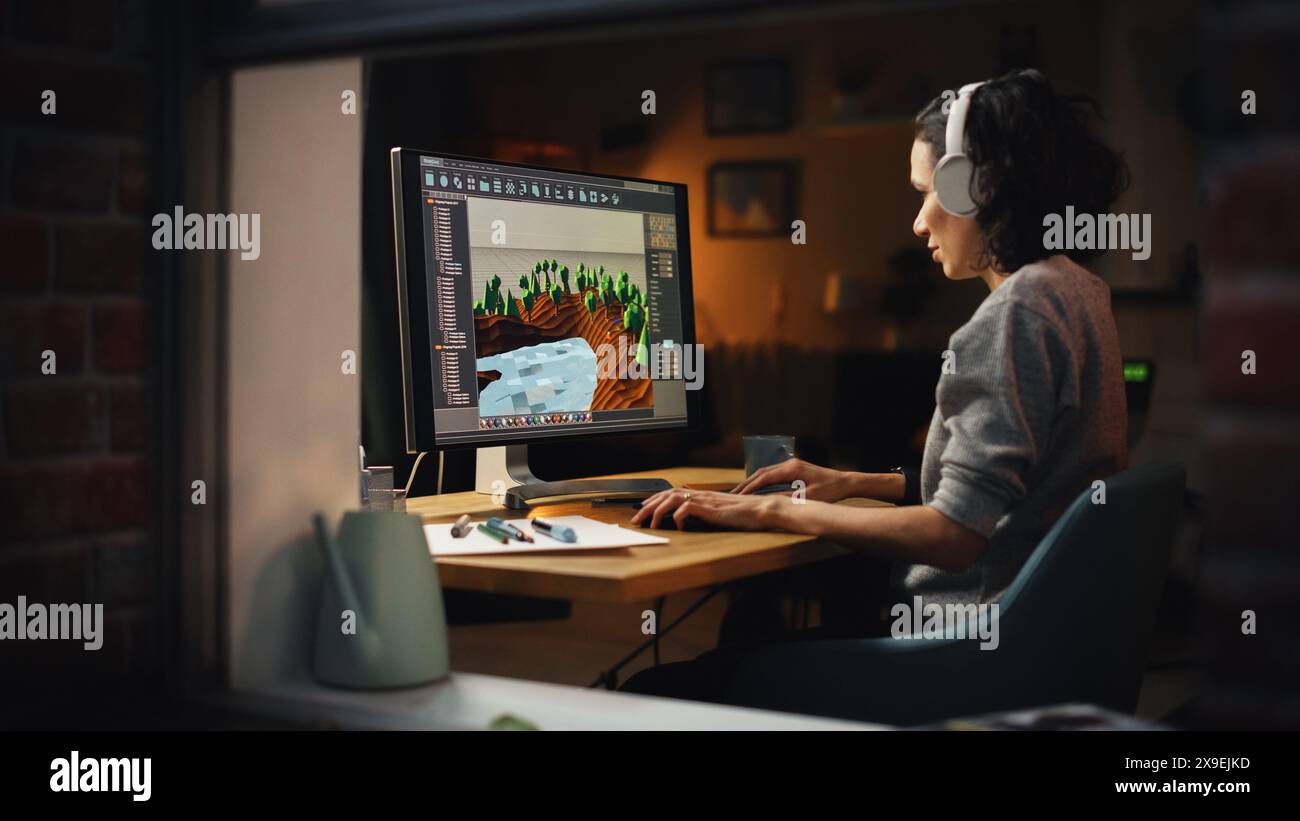 Female Video Game Designer Works on a New 3D Level on Personal Computer ...