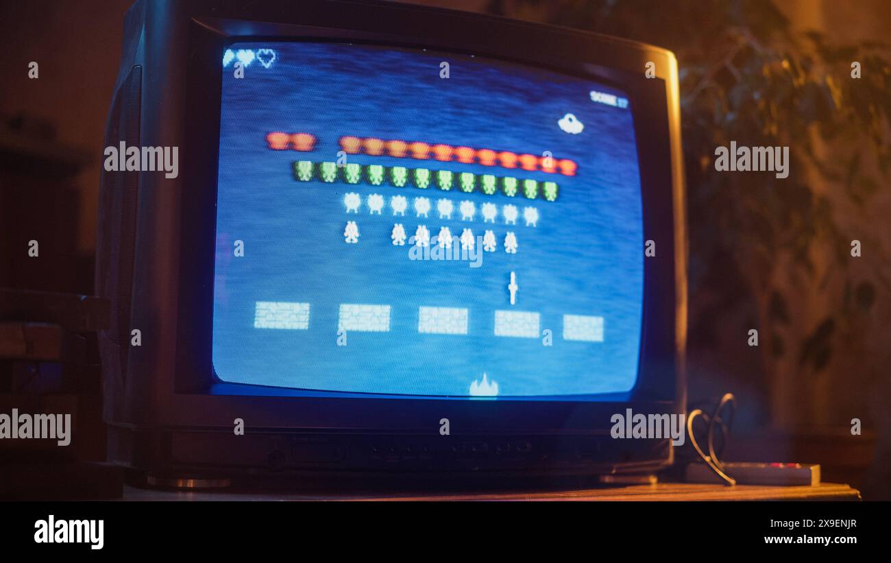 Close Up Footage of a Retro TV Set Screen with an 8 Bit 2D Eighties ...