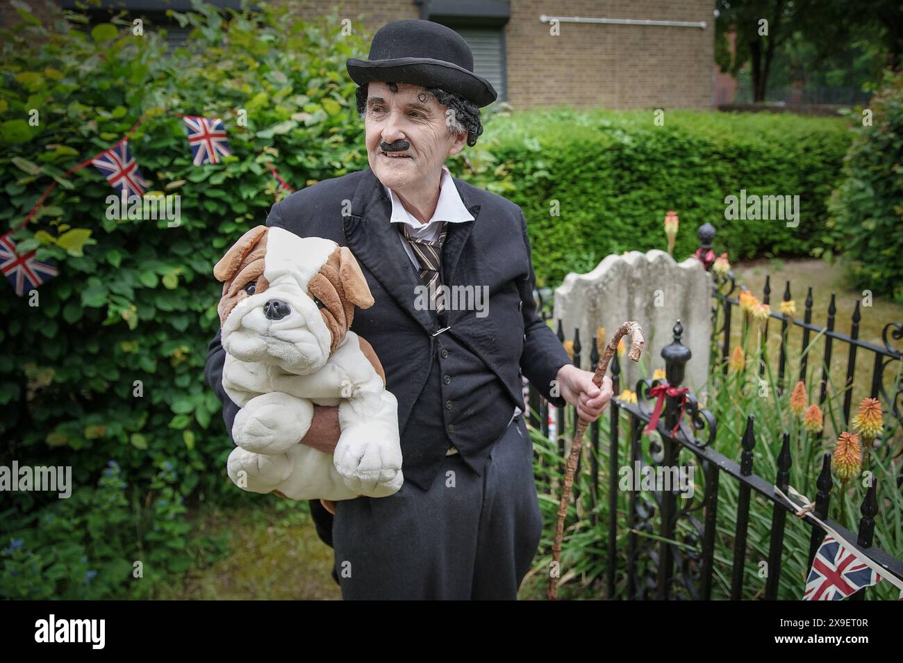 London, UK. 31st May 2024. David Girt as Charlie Chaplin arrives to pay ...