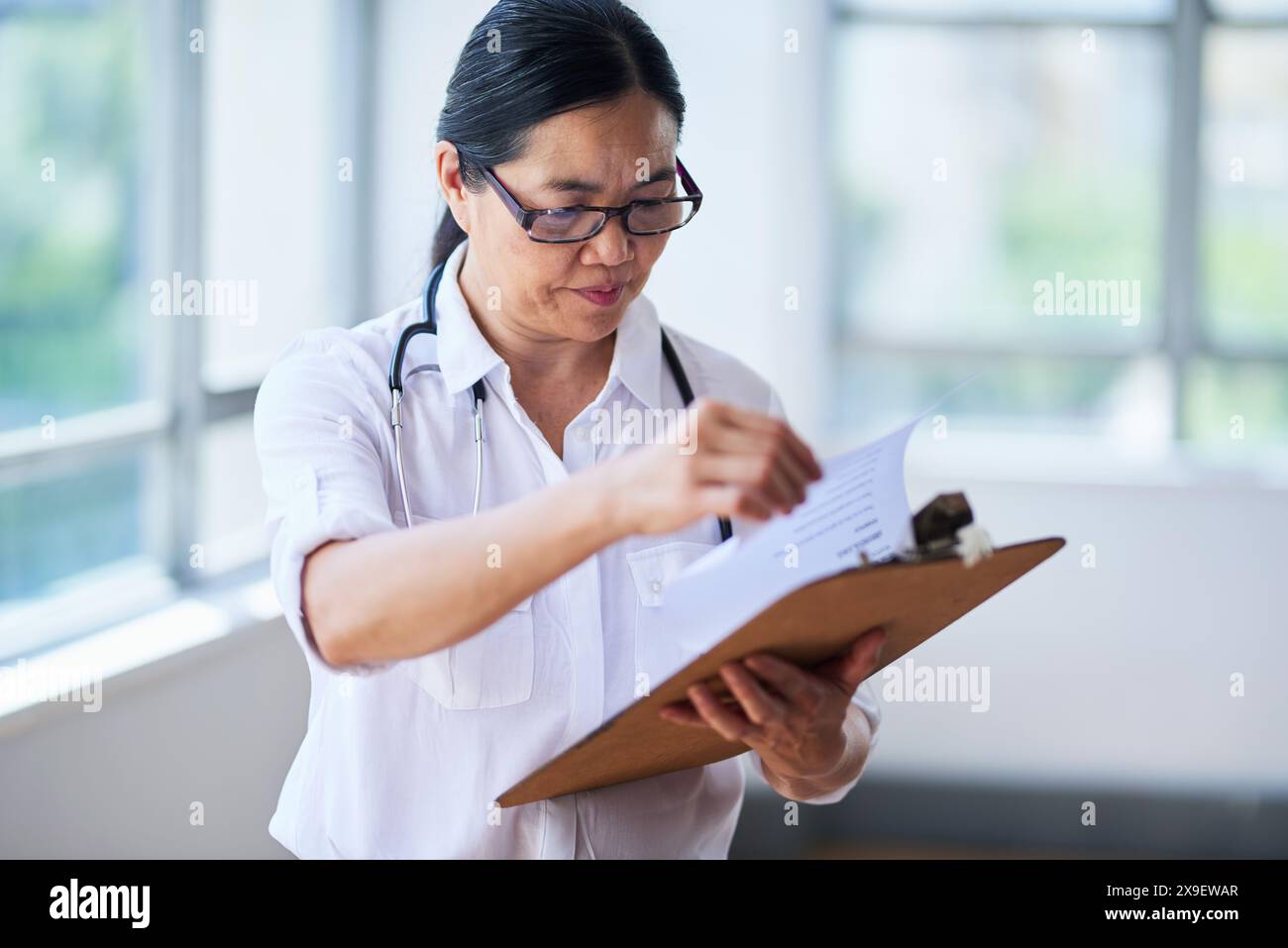 Medical staff reviewing clipboard in hi-res stock photography and ...
