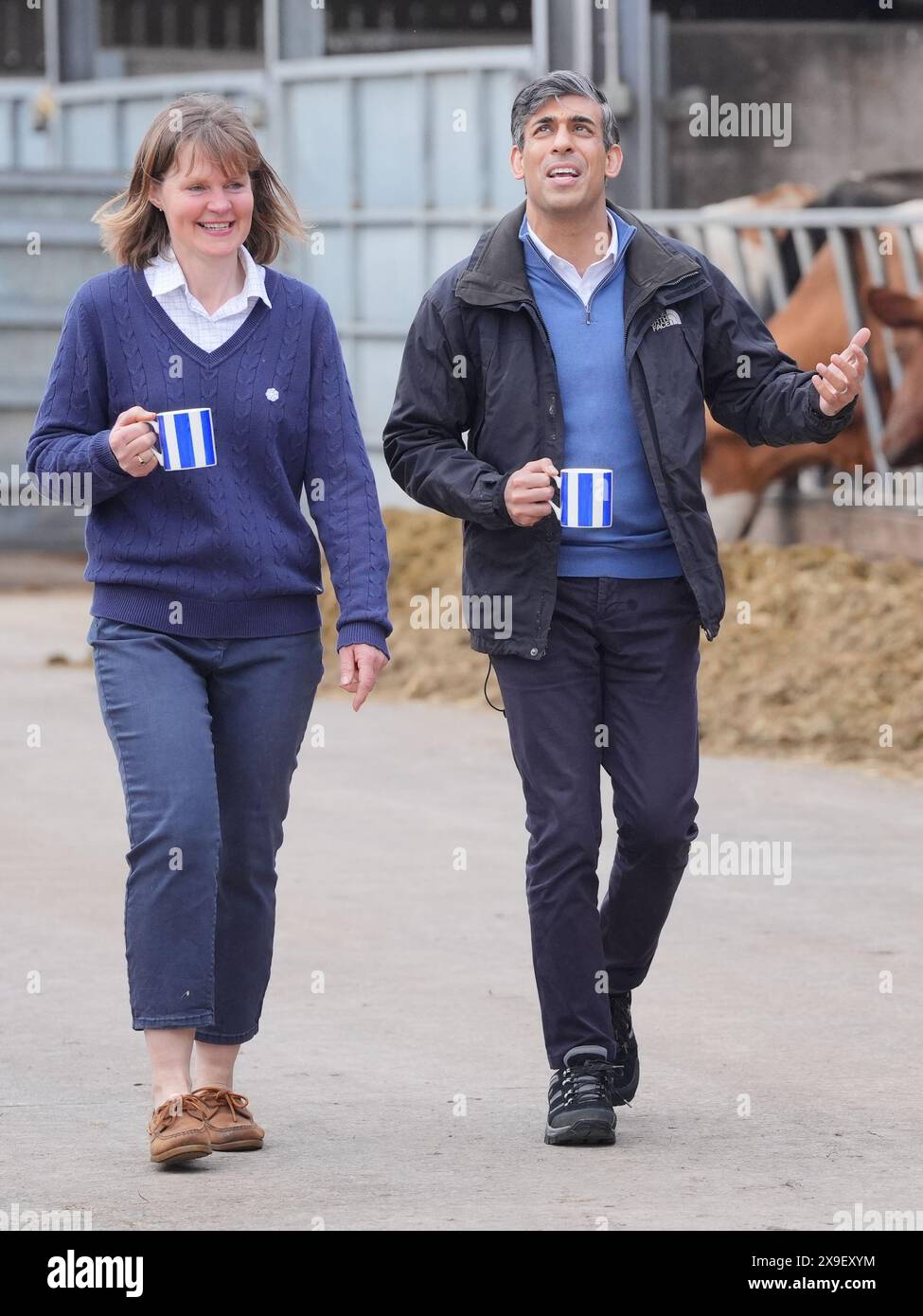 Prime Minister Rishi Sunak walks with farm owner Rachel Rowlinson ...