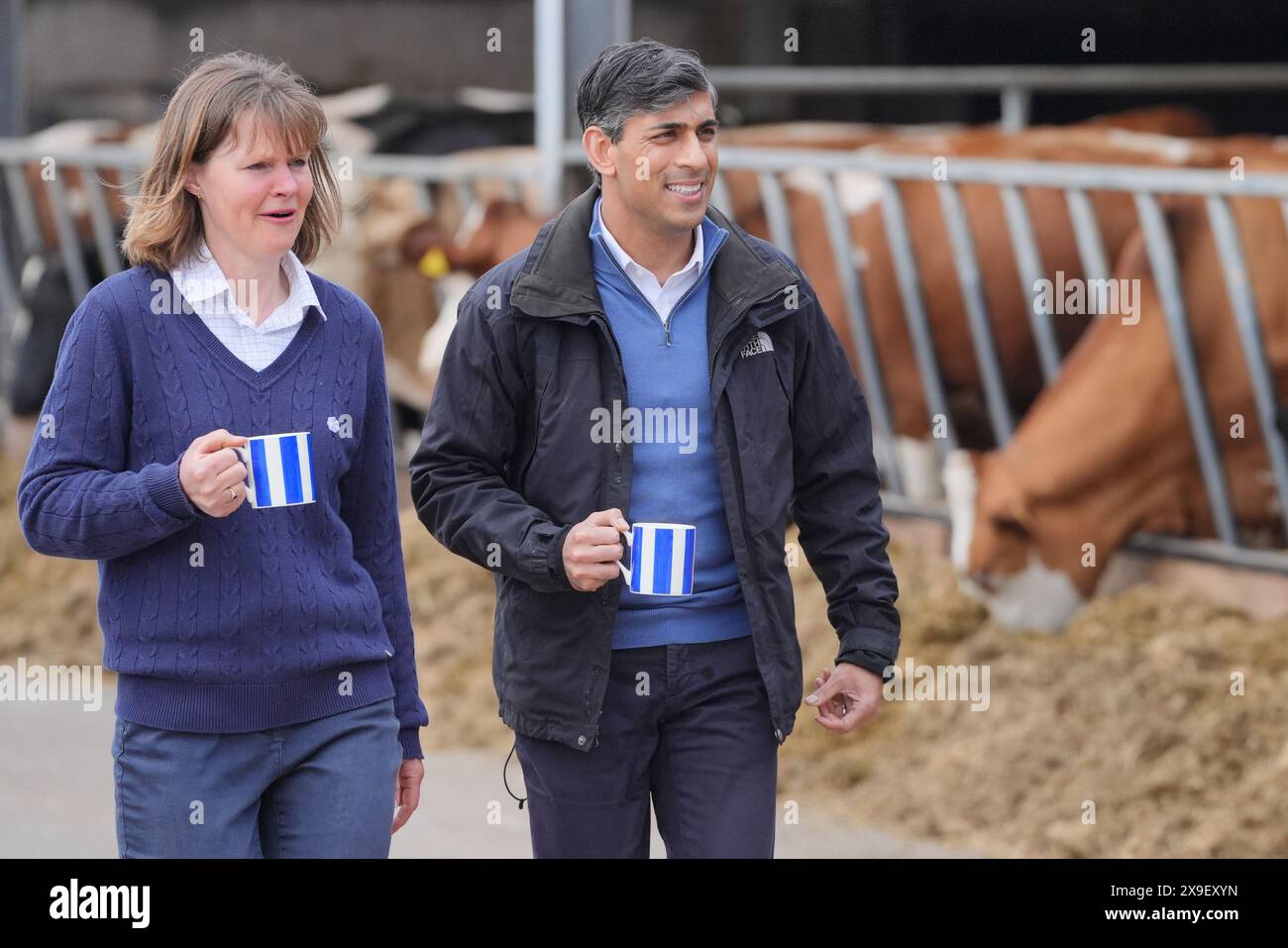 Prime Minister Rishi Sunak walks with farm owner Rachel Rowlinson ...