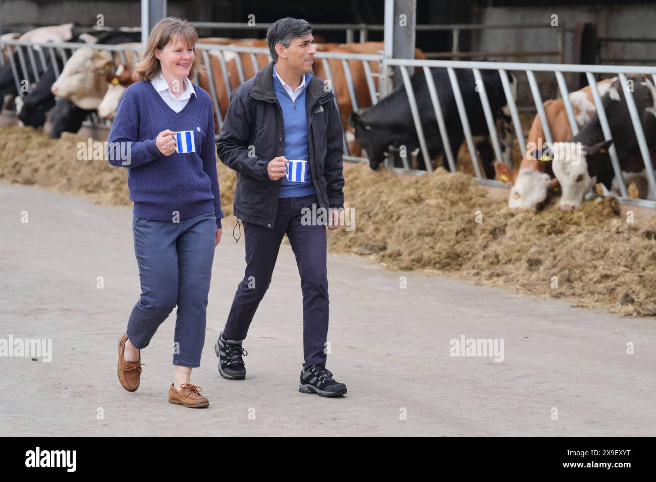 Prime Minister Rishi Sunak walks with farm owner Rachel Rowlinson ...