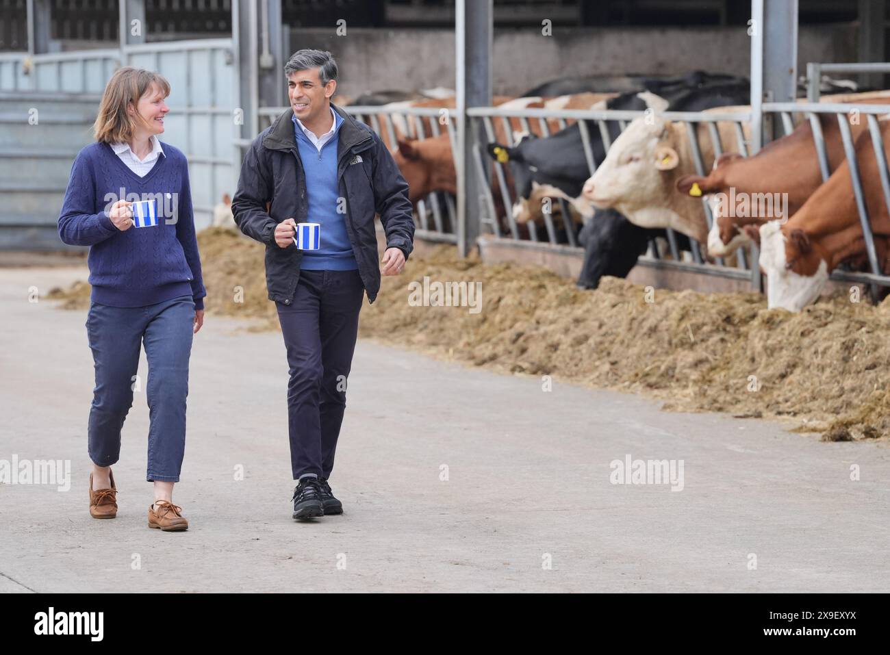 Prime Minister Rishi Sunak walks with farm owner Rachel Rowlinson ...