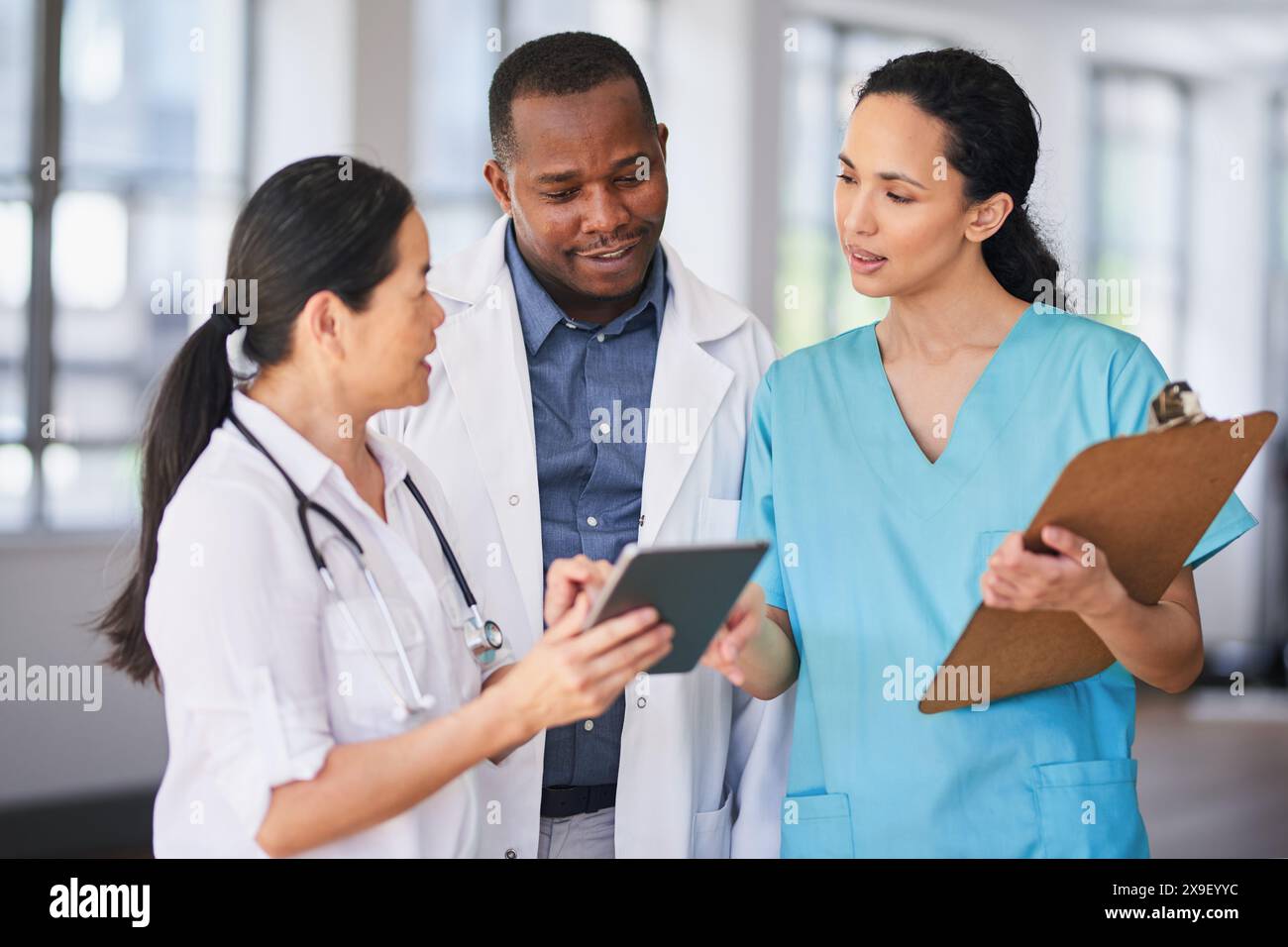 Diverse Medical Team Collaborating in Hospital Setting Stock Photo - Alamy
