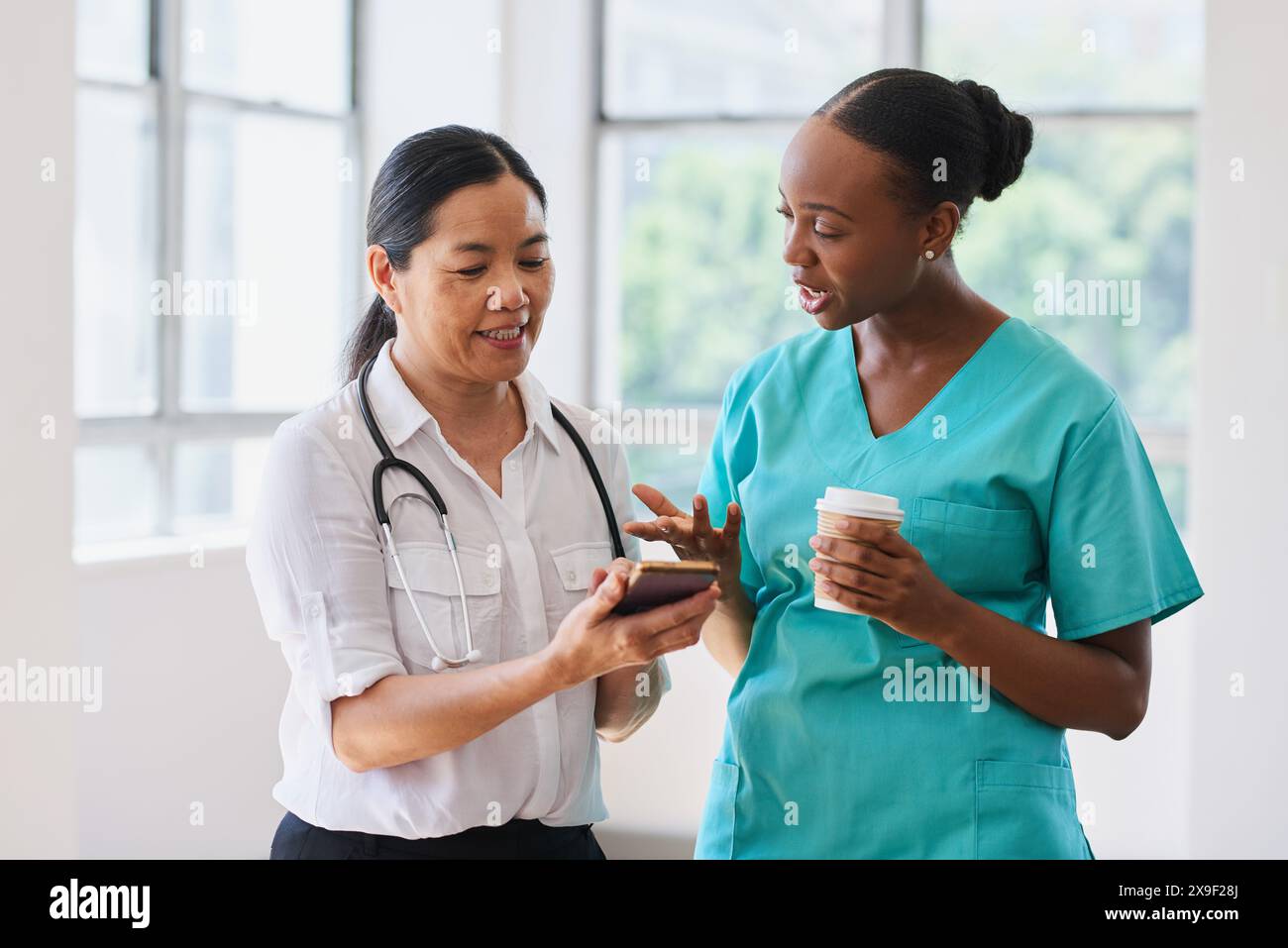 Diverse Medical Team Discussing Patient Care in Modern Hospital Setting ...