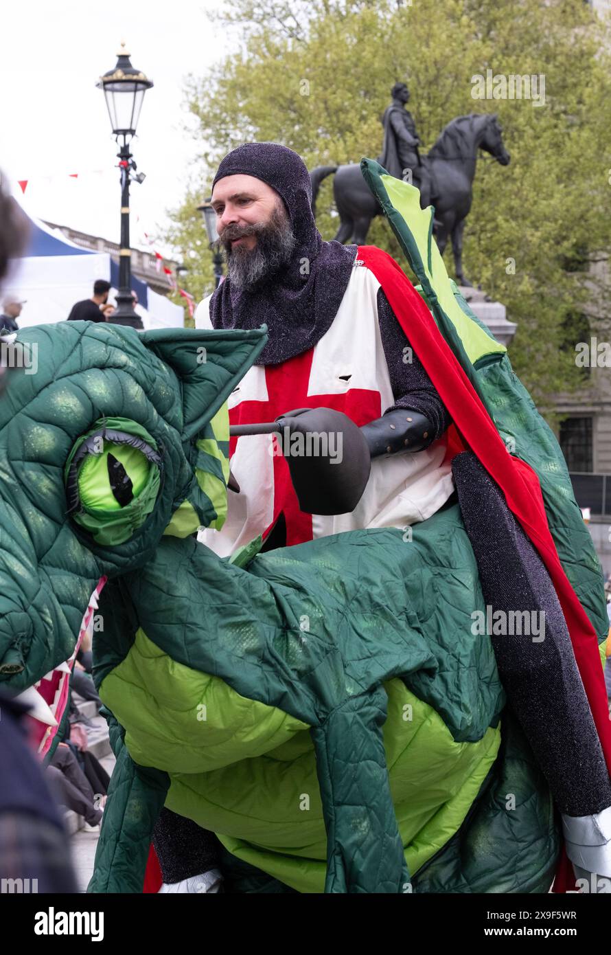 Performer dressed as St. George and riding a green dragon, meeting and ...