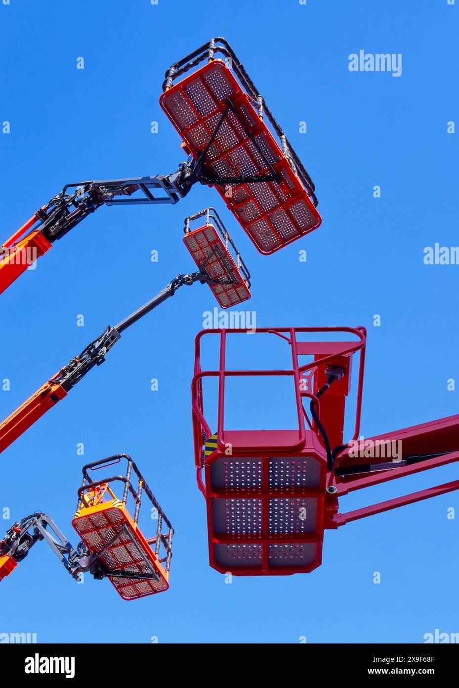 Big group of articulating cranes, baskets and hydraulic arms high in a ...