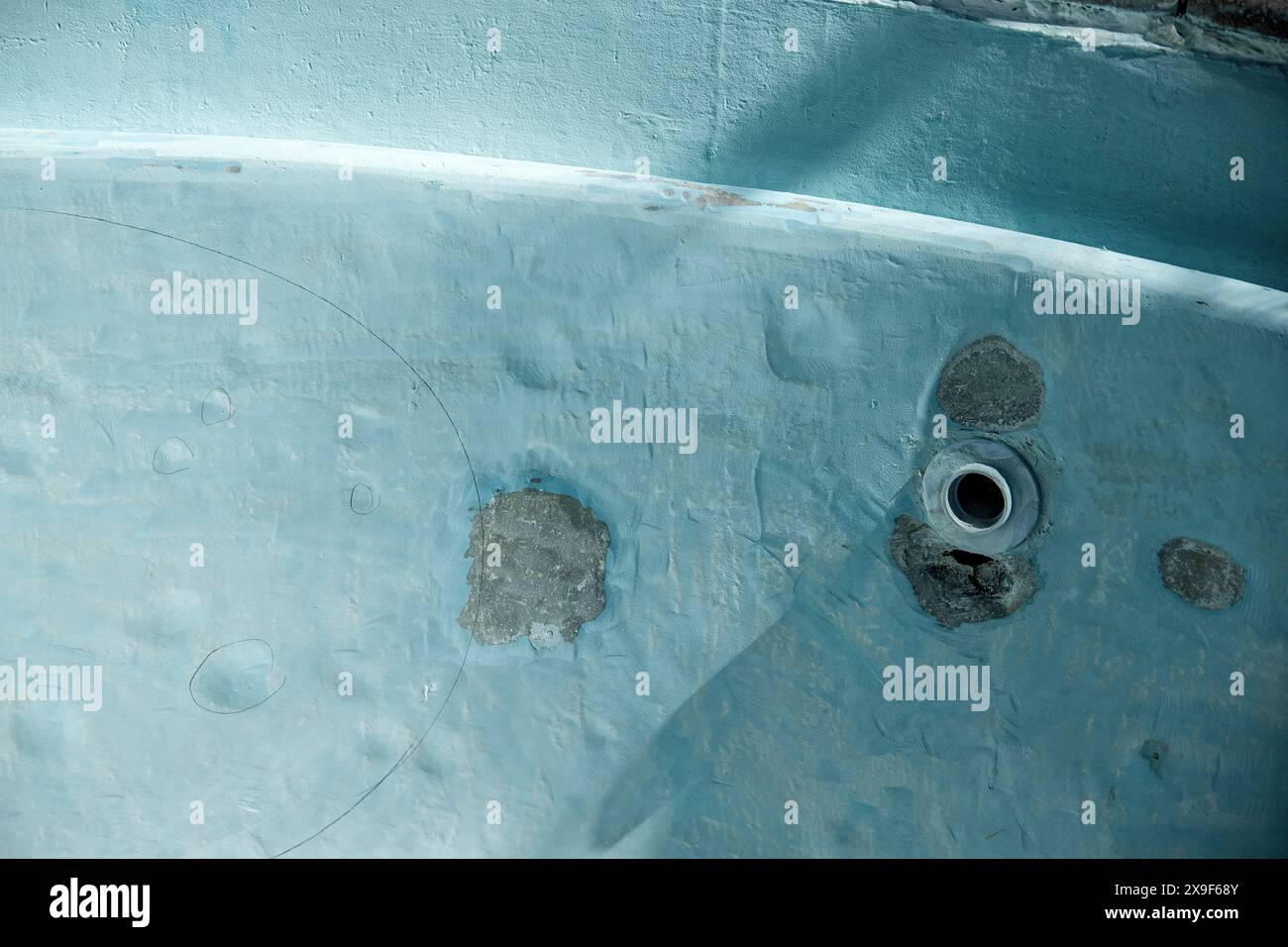 Showing bubbles in an old fibreglass pool with some ground out already ...