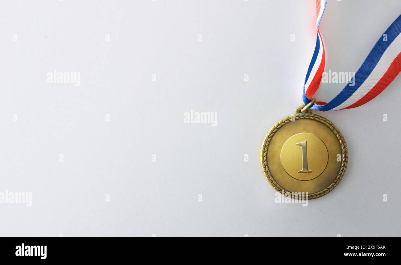 Golden metal medal with engraved number one and ribbon with blue white ...