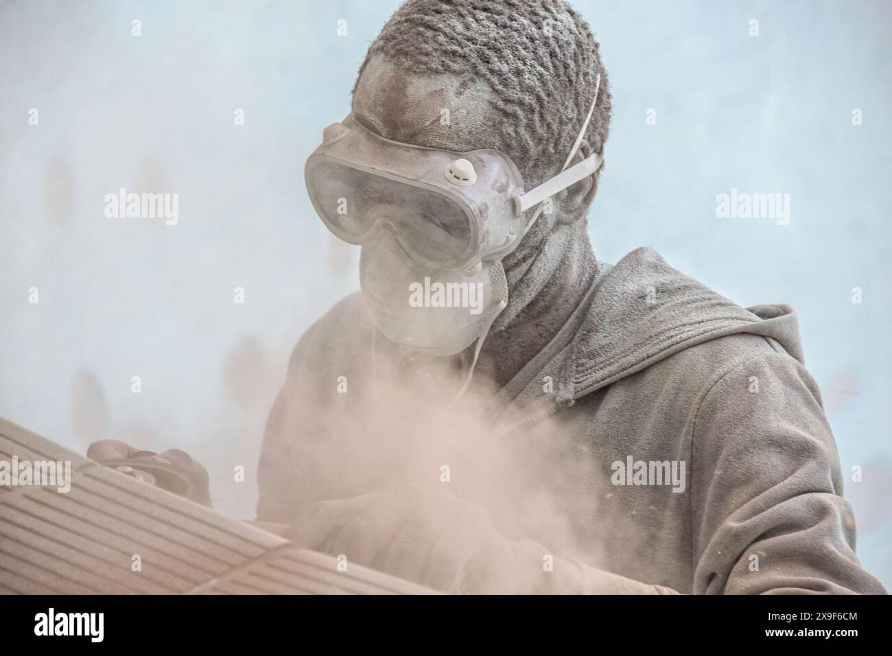 A workman grinding out the lip of old fibreglass and making dust Stock ...