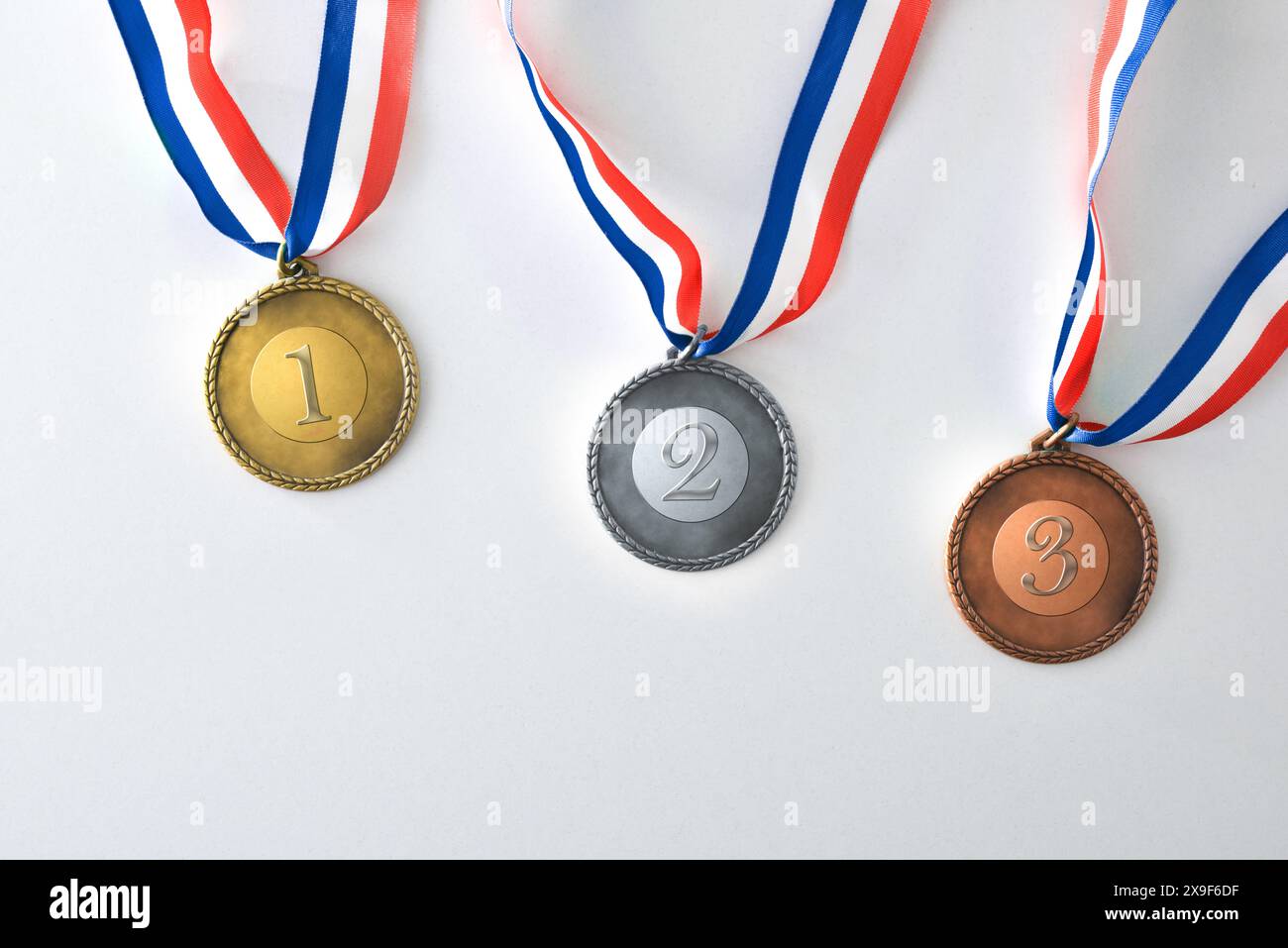 Set of metal sports competition medals with engraved position numbers ...