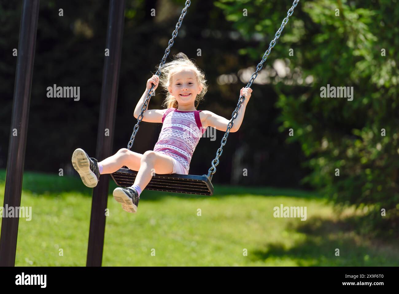 Cute Child Playing on Playground on summer season Stock Photo - Alamy