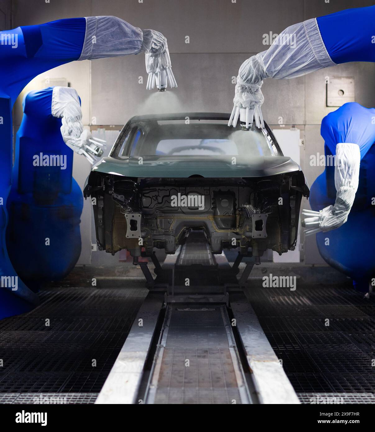 Wolfsburg, Germany. 23rd May, 2024. A Volkswagen is painted by robotic ...