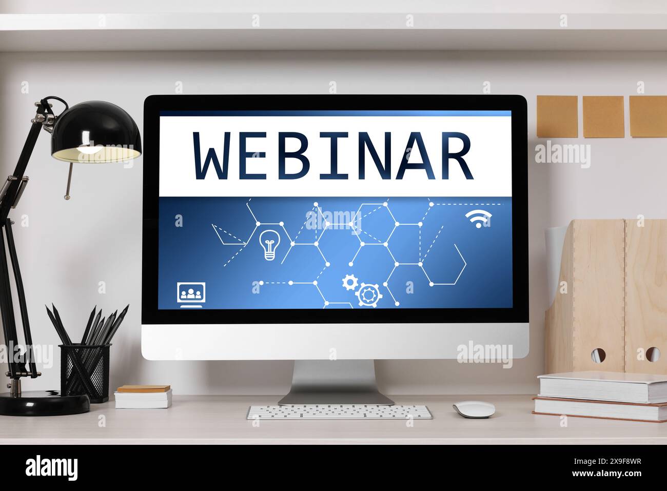 Webinar page open on computer screen at workplace Stock Photo - Alamy